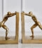 Golden Man Pushing Bookends | The Other Aesthetic